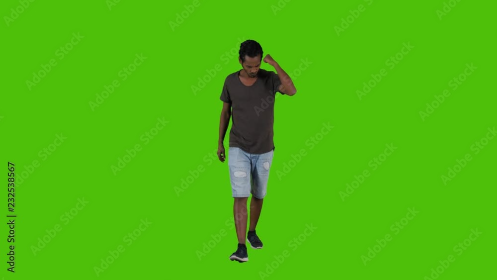 Upset young man walking annoyed and angry, a full frontal shot over a ...