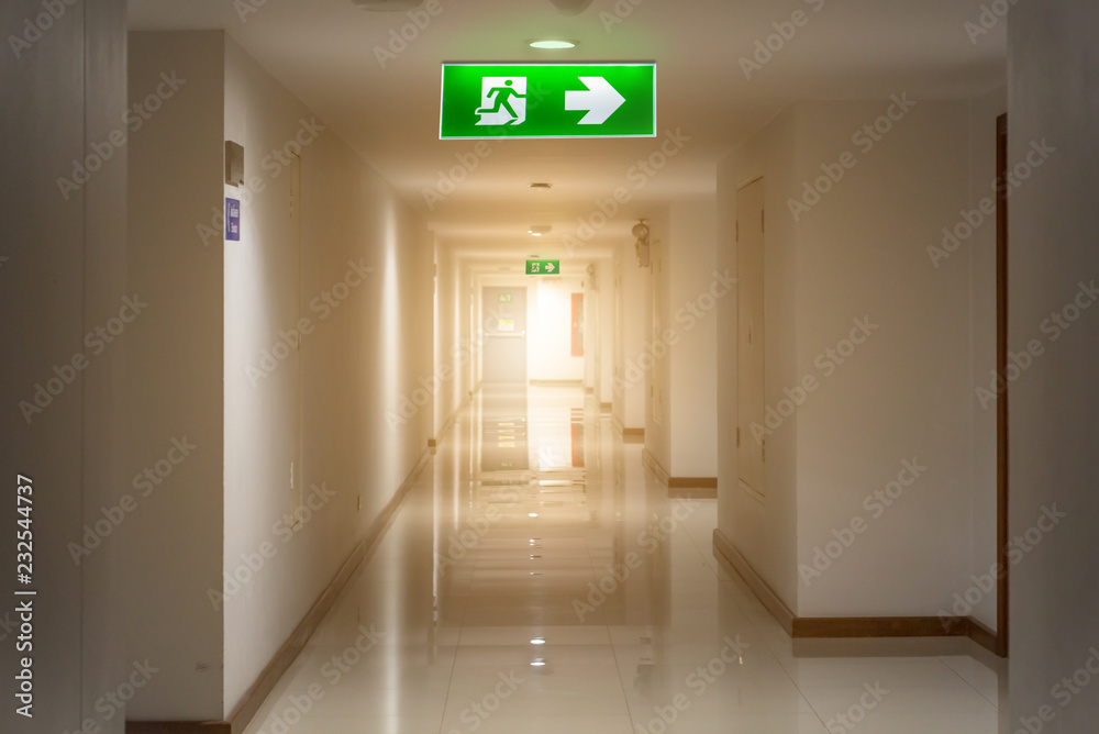 green emergency exit sign in hotel showing the way to escape Stock ...