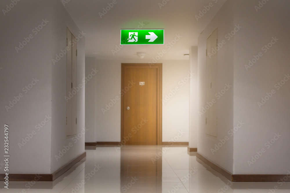 green emergency exit sign in hotel showing the way to escape Stock ...