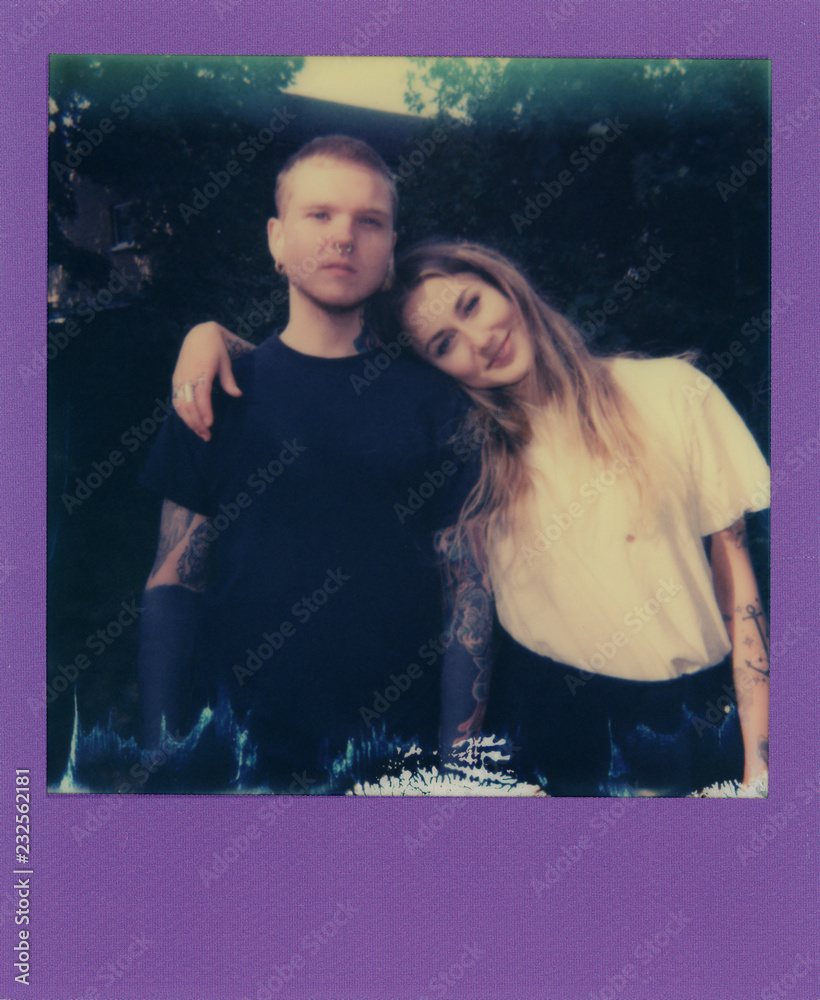 Polaroid scan of a heavily tattooed man with back to the camera and a ...