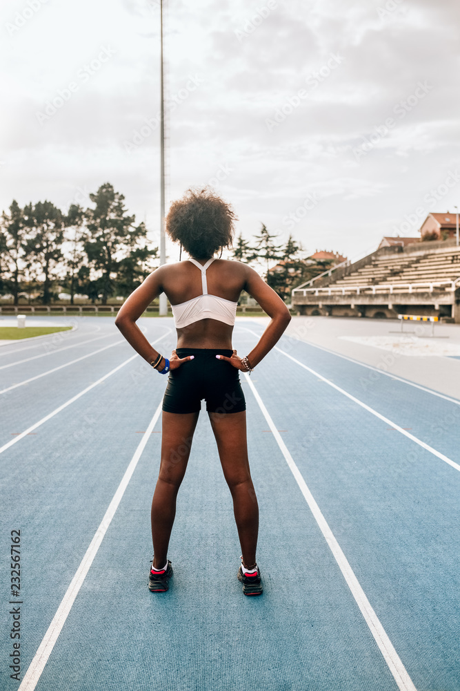 Black woman athlete on her back in an athletics stadium Stock Photo ...