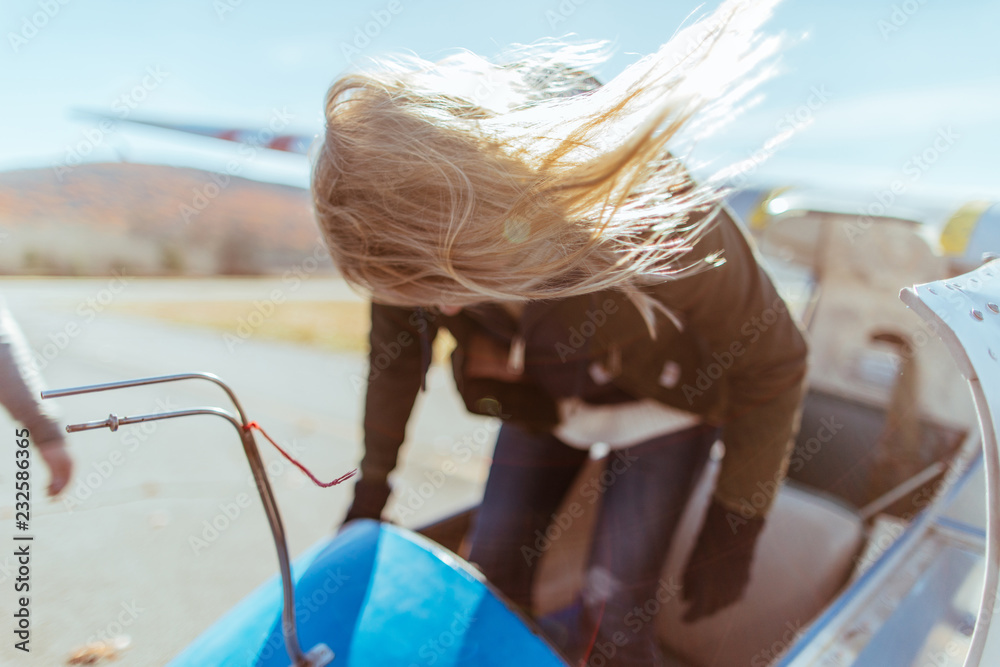 Woman boarding a glider plane Stock Photo | Adobe Stock