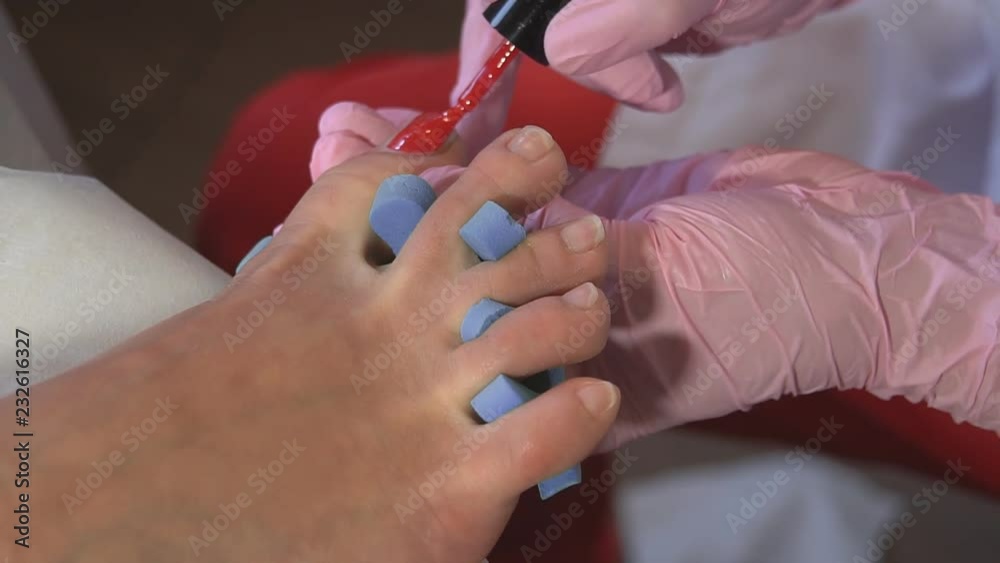Pedicures in the salon. The master cares for the nails and feet of the ...