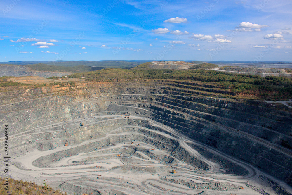 Aerial view industrial of opencast mining quarry with lots of machinery ...