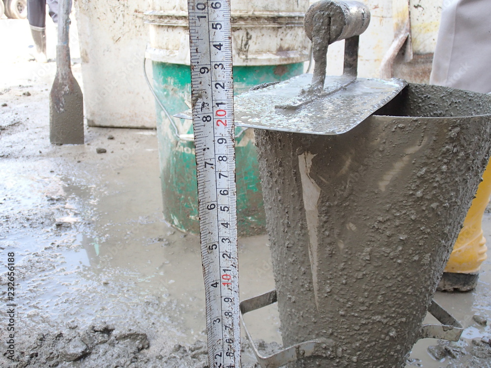 Construction workers doing slump test using specific equipment at the ...
