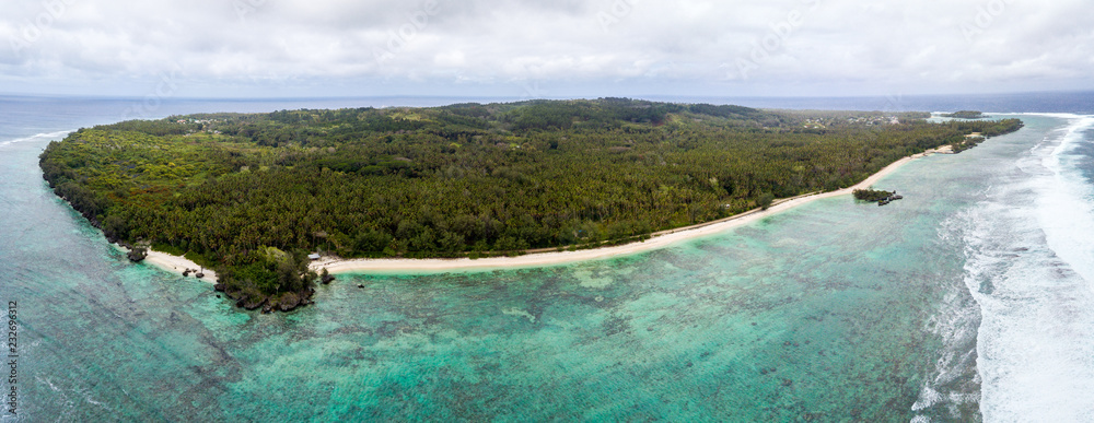 Aerial view of Rimatara island with yellow sandy beaches in azure ...