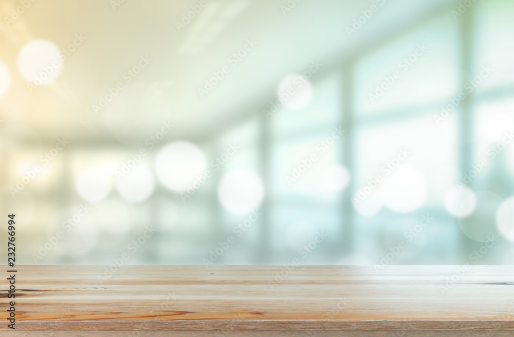 Wooden desk with Blurred of interior office room with city building ...