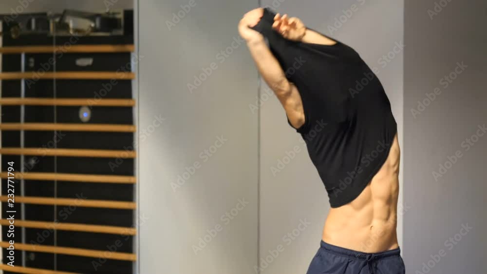 Athletic young man opening sweater on naked muscular pecs, abs and ...