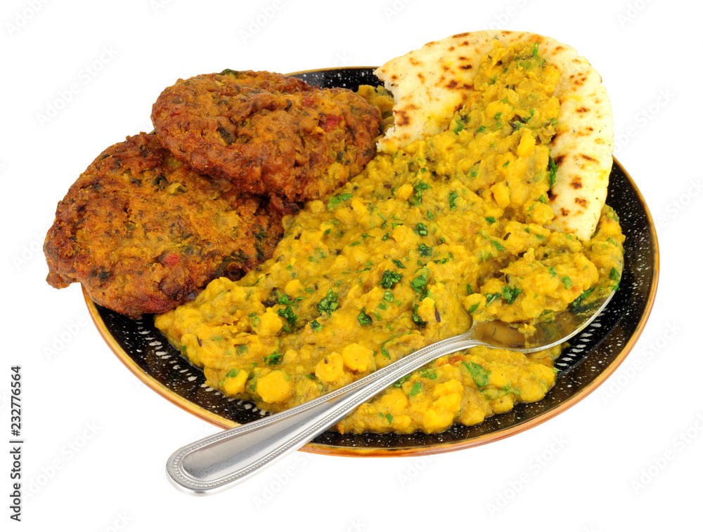 Indian tarka daal meal with onion bhaji and naan bread isolated on a ...