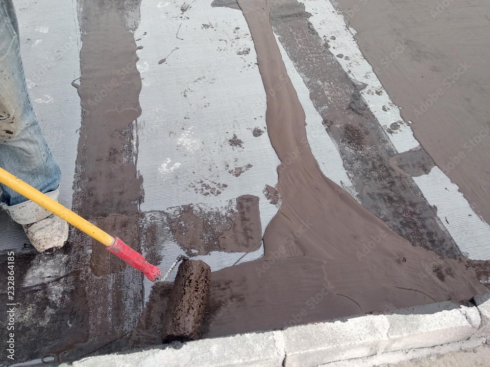 Waterproofing membrane applied by construction workers on top of ...