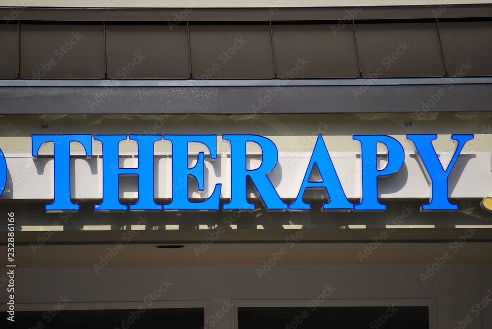 Poster Therapy sign displayed on a wall outside. – Wall Art | UkPosters