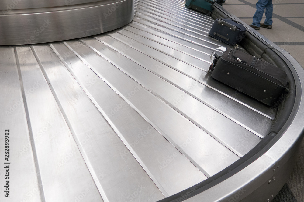Luggage on an airport baggage carousel Stock Photo | Adobe Stock