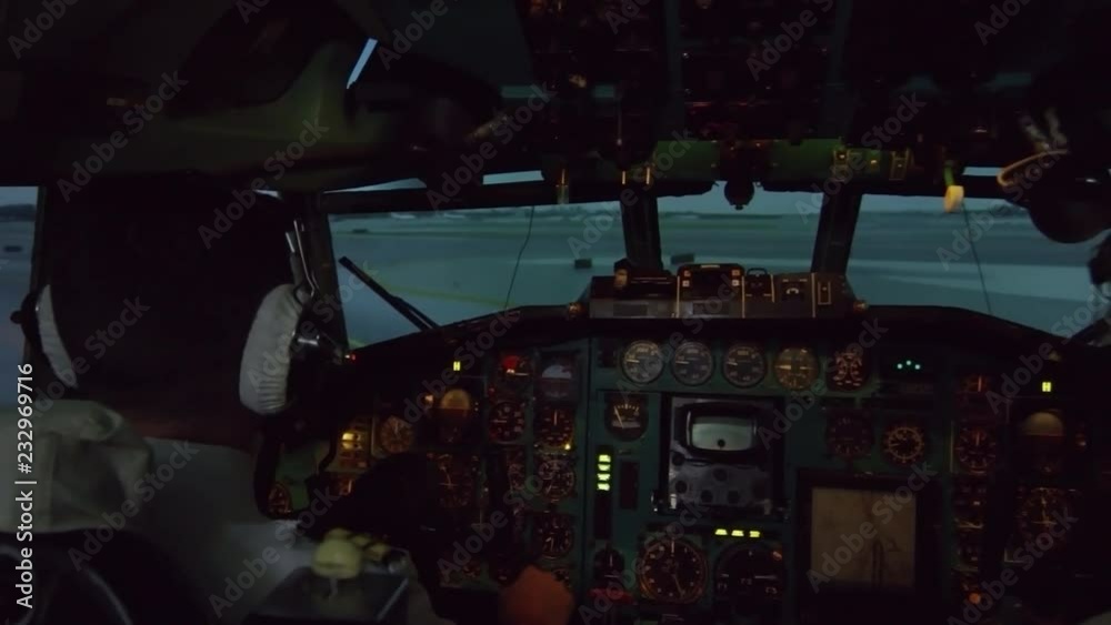 PAN shot from inside of cockpit: male aircraft captain talking to co ...