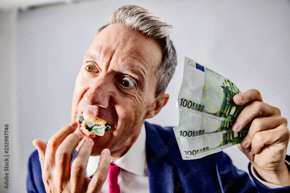 Euro, Euroschine Mann isst Geld Stock Photo | Adobe Stock