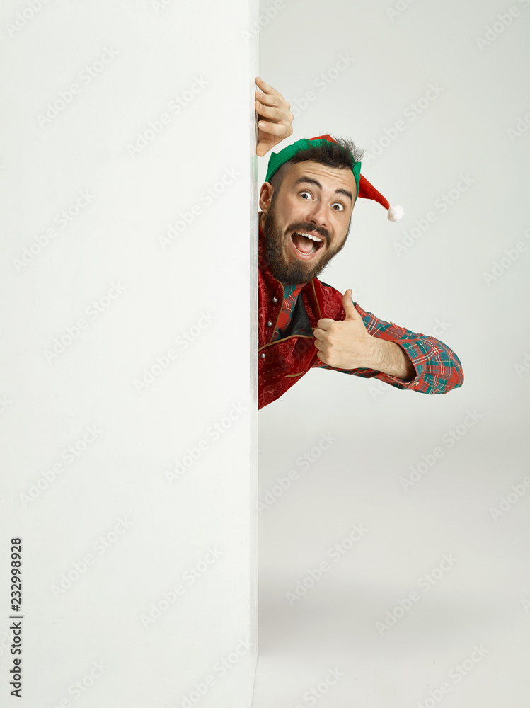 The happy smiling friendly man dressed like a funny gnome or elf posing ...