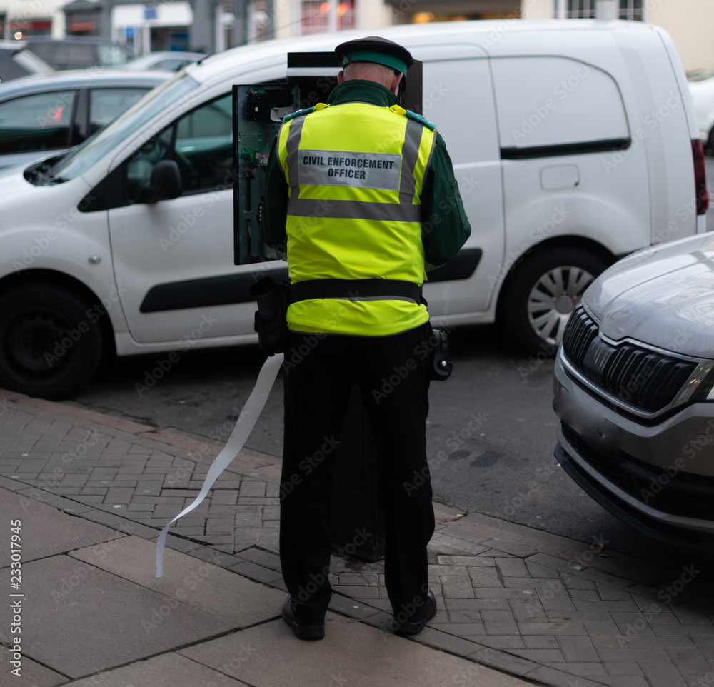 civil enforcement officer traffic warden tries to fix parking meter in ...