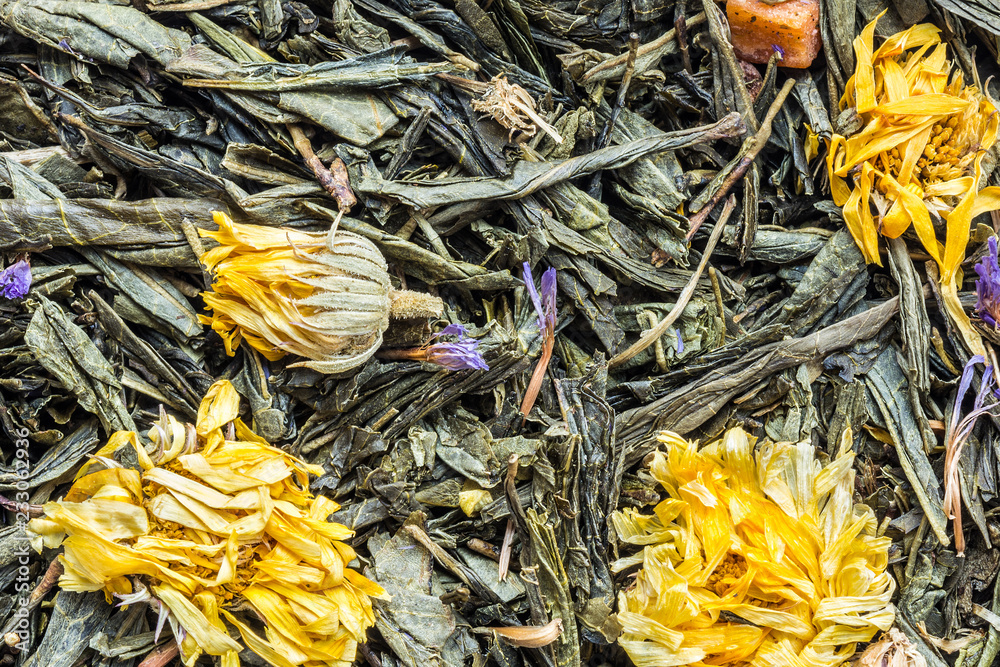 texture of dry green tea with dandelion flowers, closeup herbal drink ...