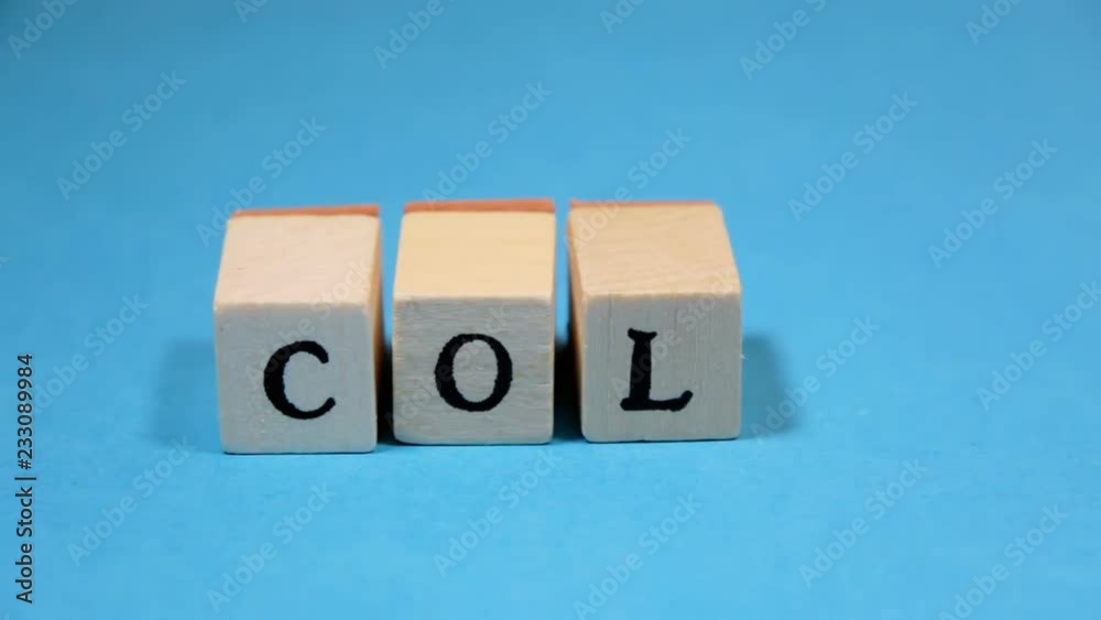 Composing the word Cold with wooden letters on a light blue background ...