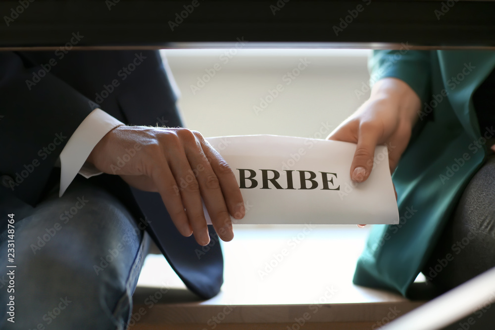Businessman taking bribe from woman under table, closeup. Corruption ...