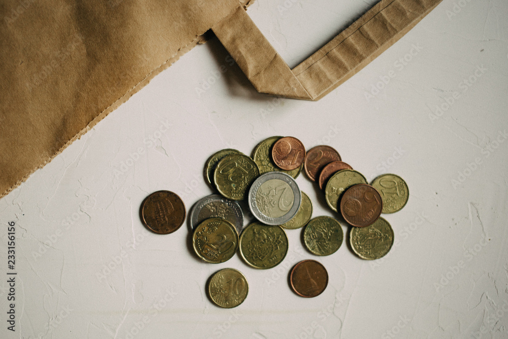 Cash money, euro coins with a Kraft package on white textured ...