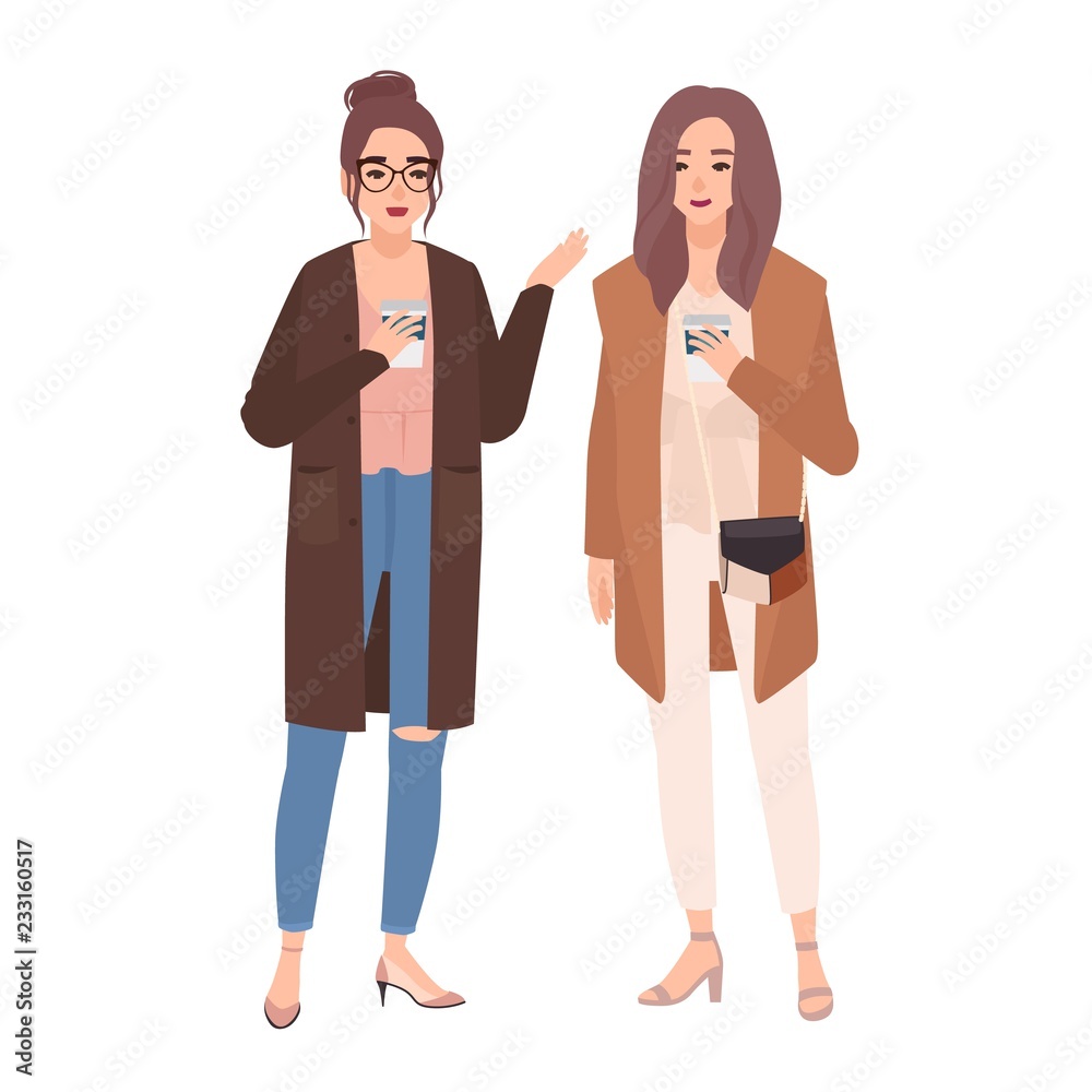 Pair of two young pretty smiling women standing together, drinking ...