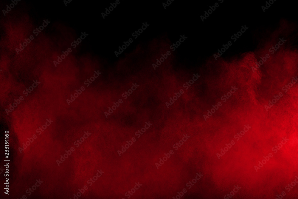 Red powder explosion on black background. Freeze motion of Red dust ...