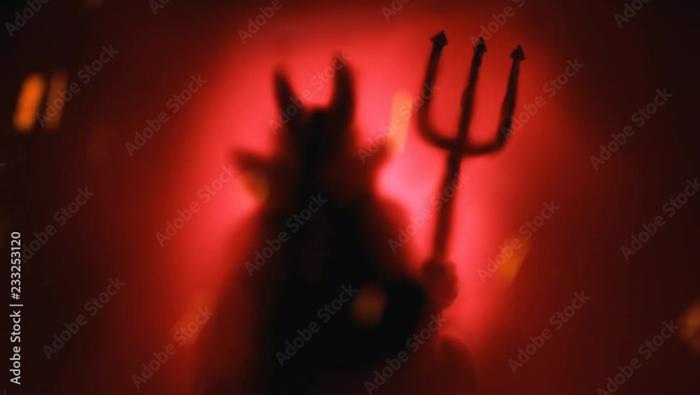 Animated Creepy Devil silhouette from hell in the mist with backlit ...