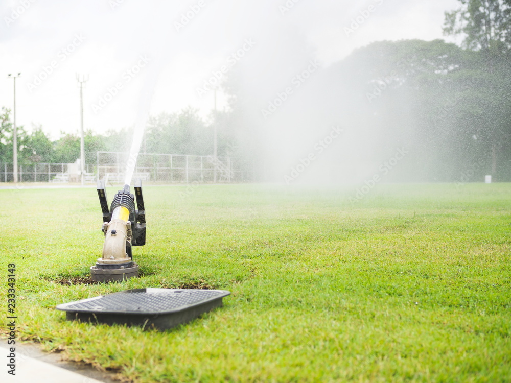 Sprinkler watering football field, Sprinkler watering green grass in ...