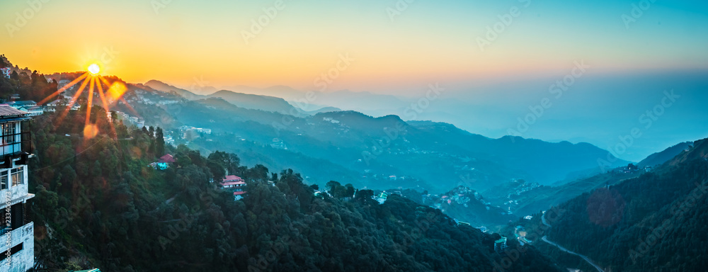sunrise forming winter line in mussoorie India . layers of mountains ...