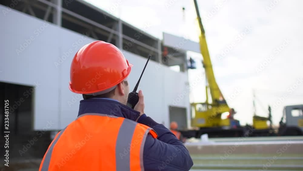 Male engineer, builder, foreman, worker in orange a uniform and hard ...