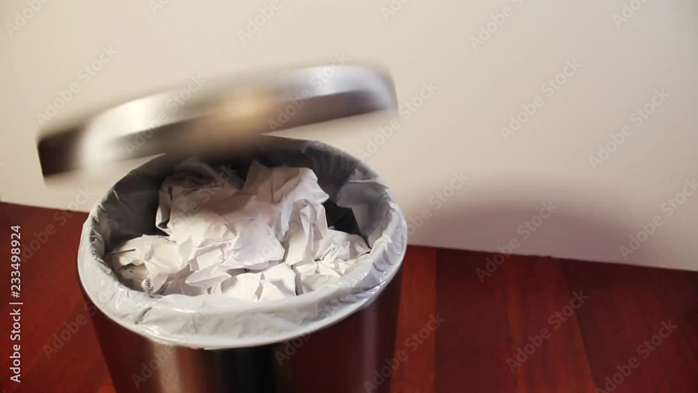 Throwing away trash in the garbage and closing the lid. Smart recycling ...