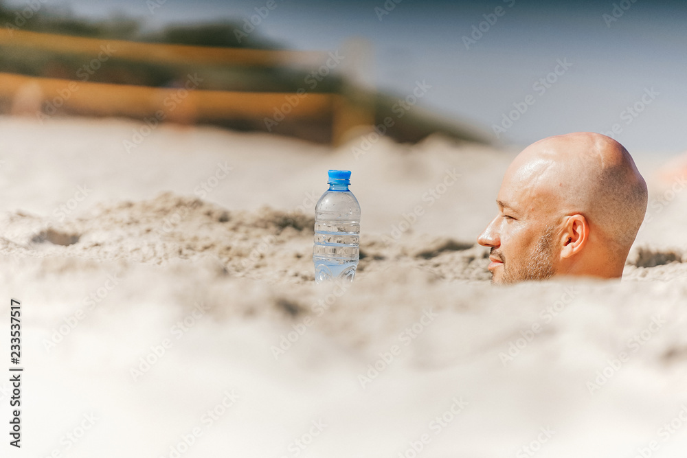 Buried till head bald man. Suffering of thirsty male in desert. Young ...