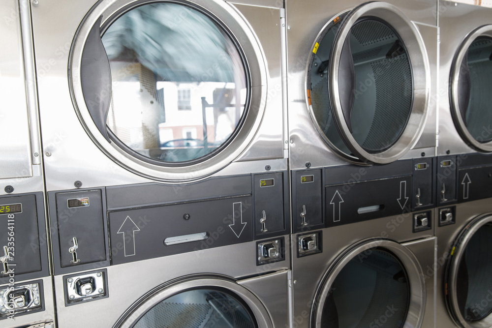 self-service laundry facilities concept - washing machines with clothes ...