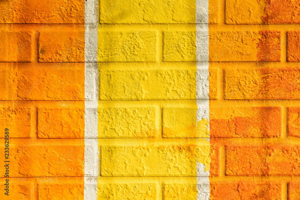 Bricks surface of wall, painted vertical lines in orange and yellow ...