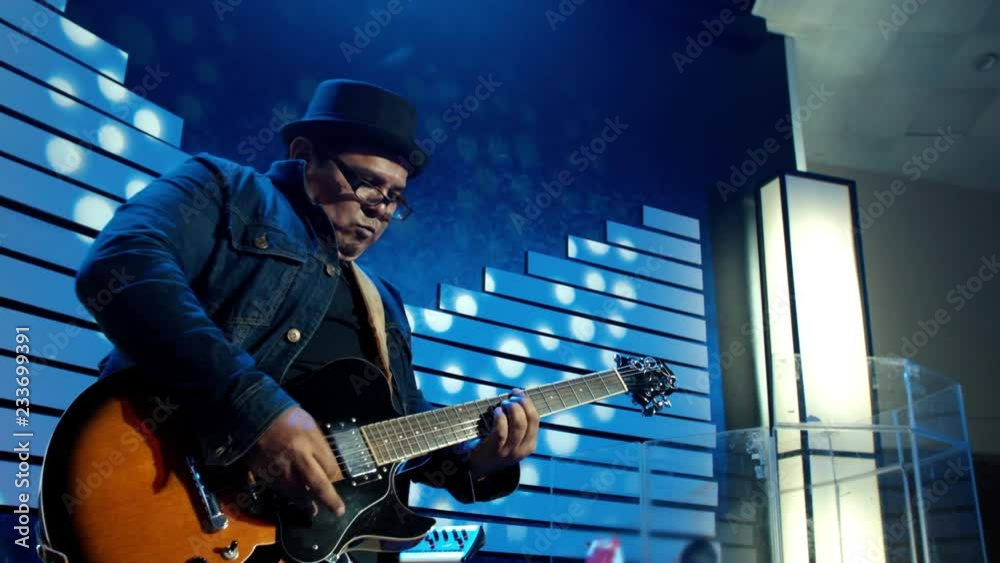 Hispanic electric guitar player rocking on stage. Latin musician ...