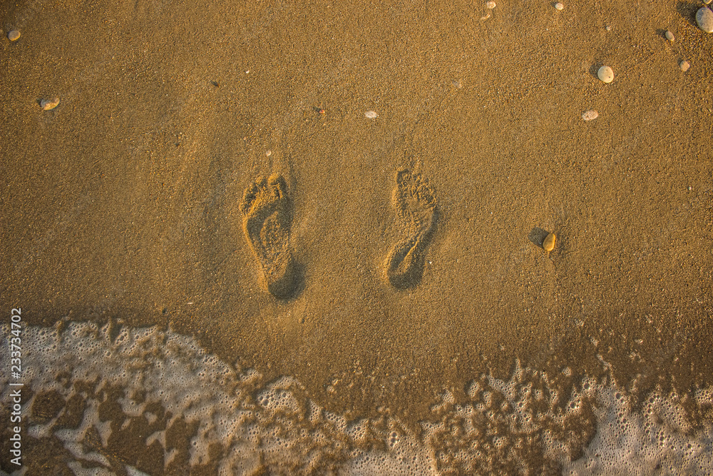 human footprints on sea sand shore waterfront district background ...