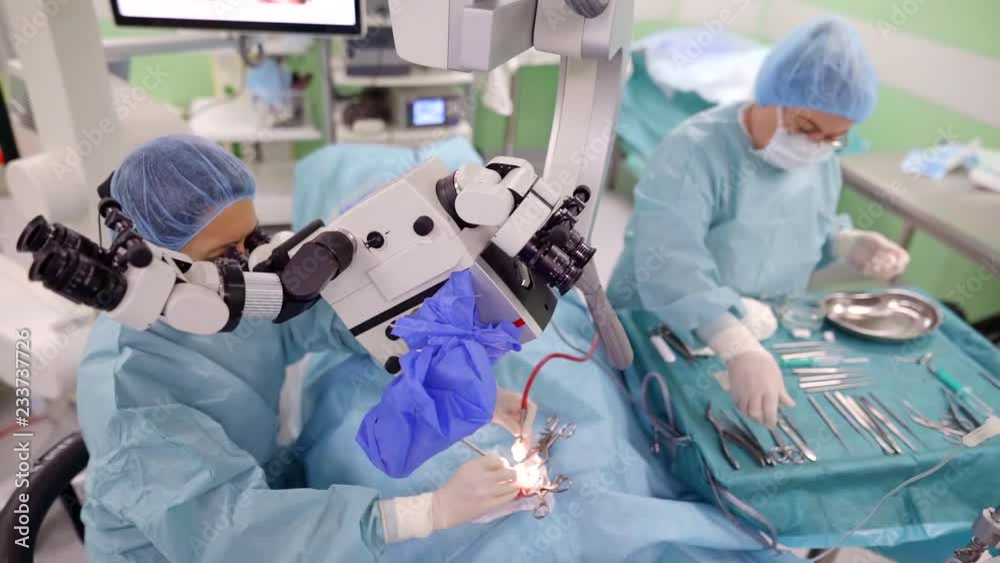 Video Stock ent surgeon is operating ear of patient and installing a ...