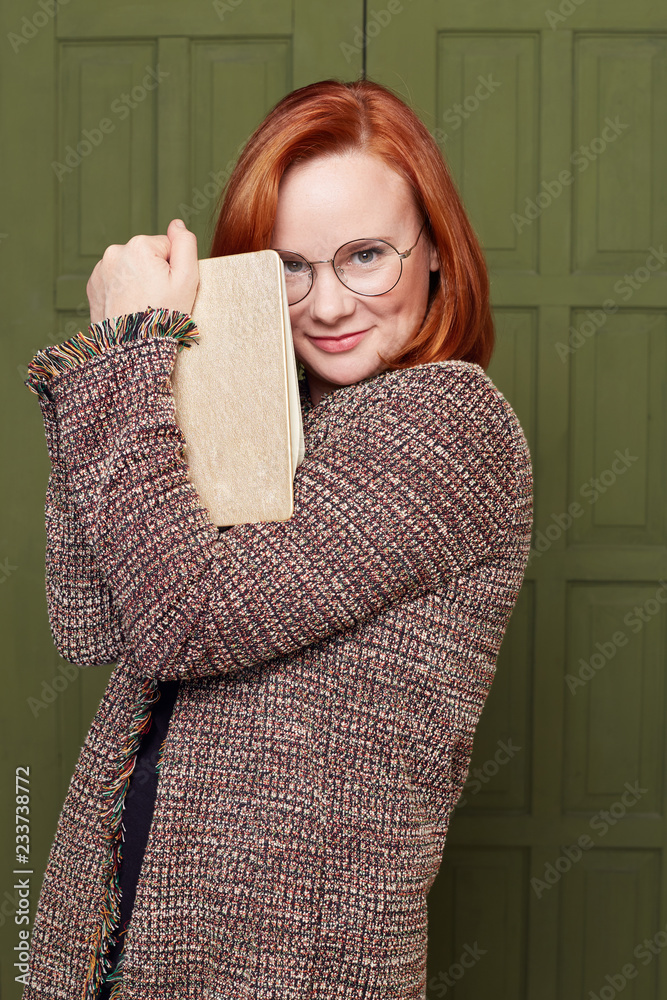 People, education, reading concept. Attractive ginger female student ...