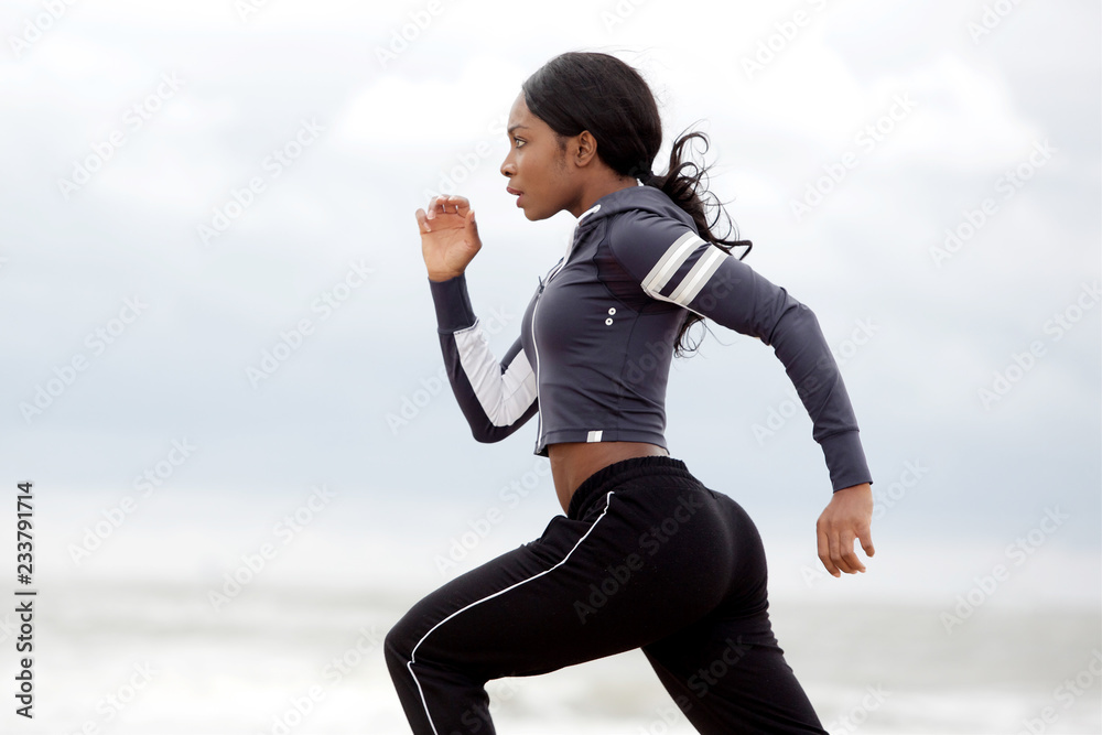 sporty young black woman running Stock Photo | Adobe Stock
