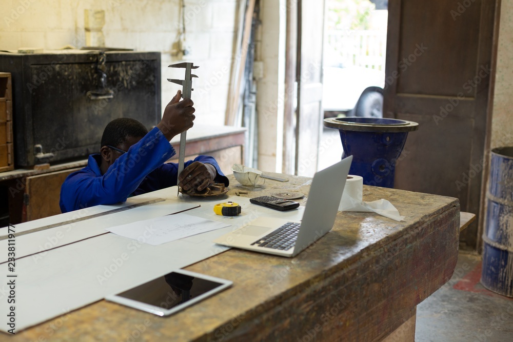 Worker using vernier caliper in foundry workshop Stock Photo | Adobe Stock