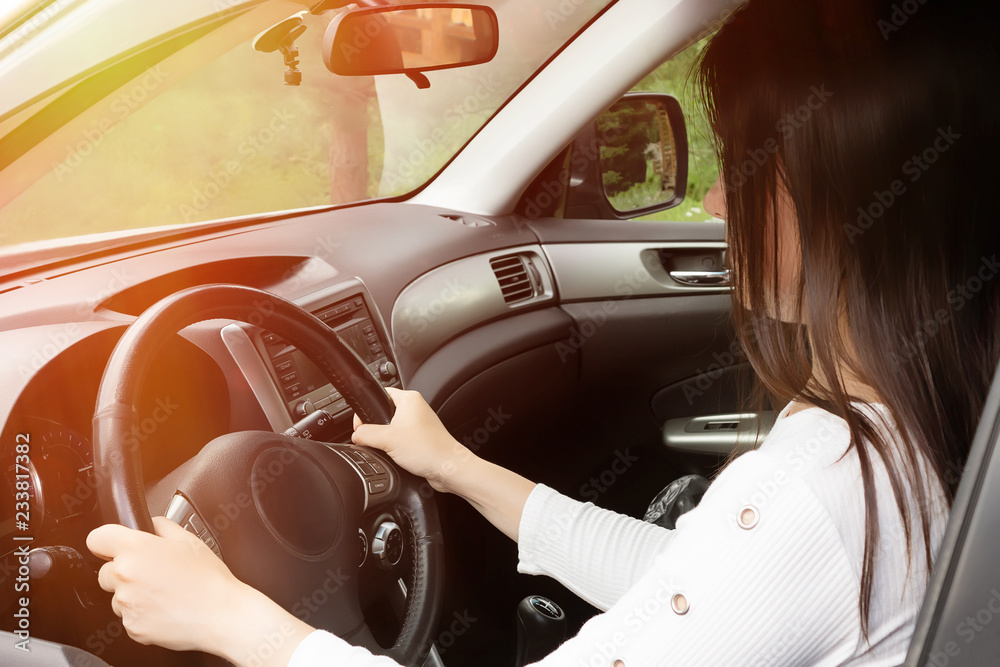 Young girl with long dark hair driving a car Stock Photo | Adobe Stock