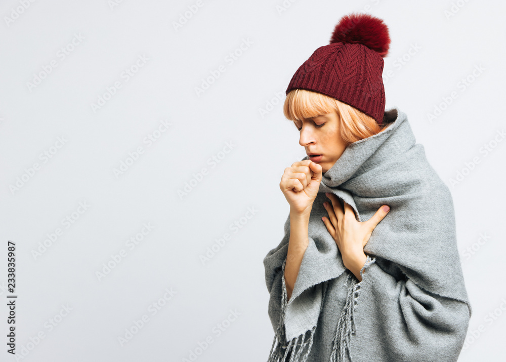 Cute sick young teen woman in red hat, wrapped in warm scarf coughing ...