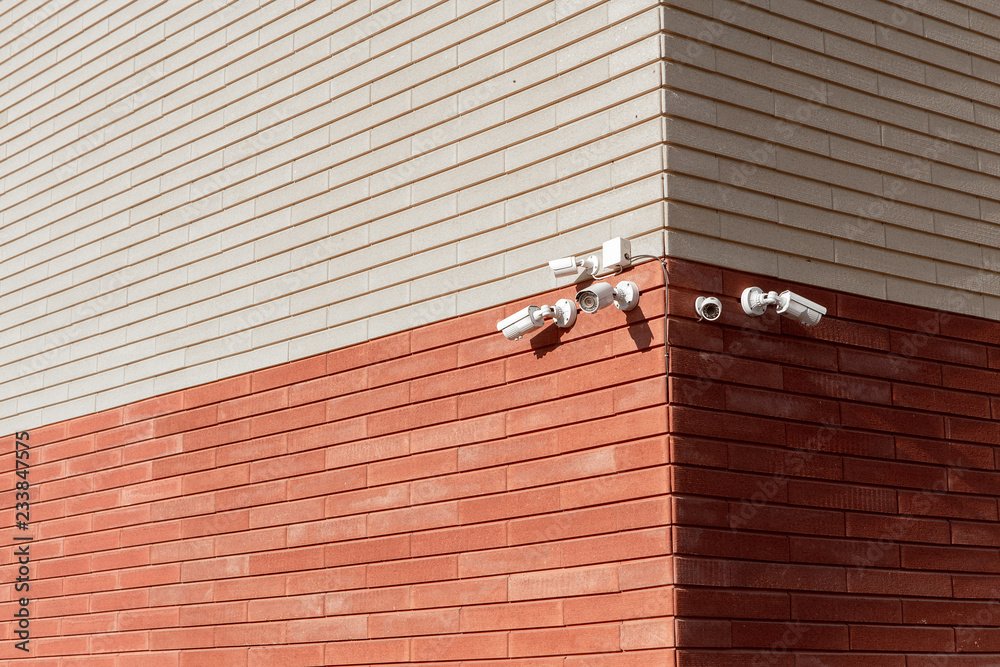 CCTV cameras on the wall. Monitor the security of a multi-story ...