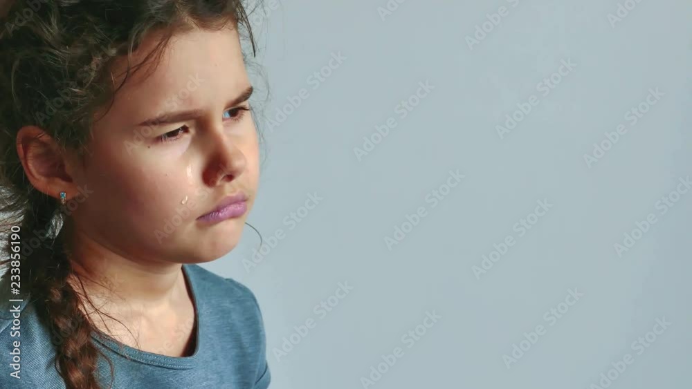 sad and depressed little girl worth crying on a white background ...
