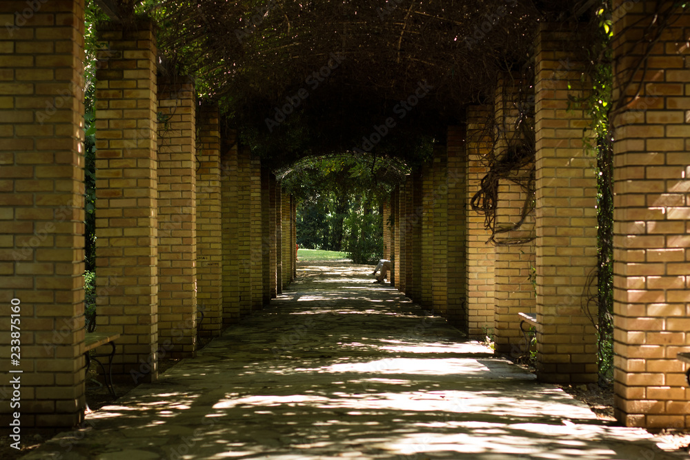 soft focus park outdoor closed alley way under roof with brick columns ...