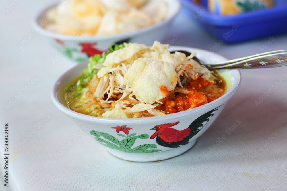rice porridge, known in Indonesia as bubur ayam, served on the bowl ...