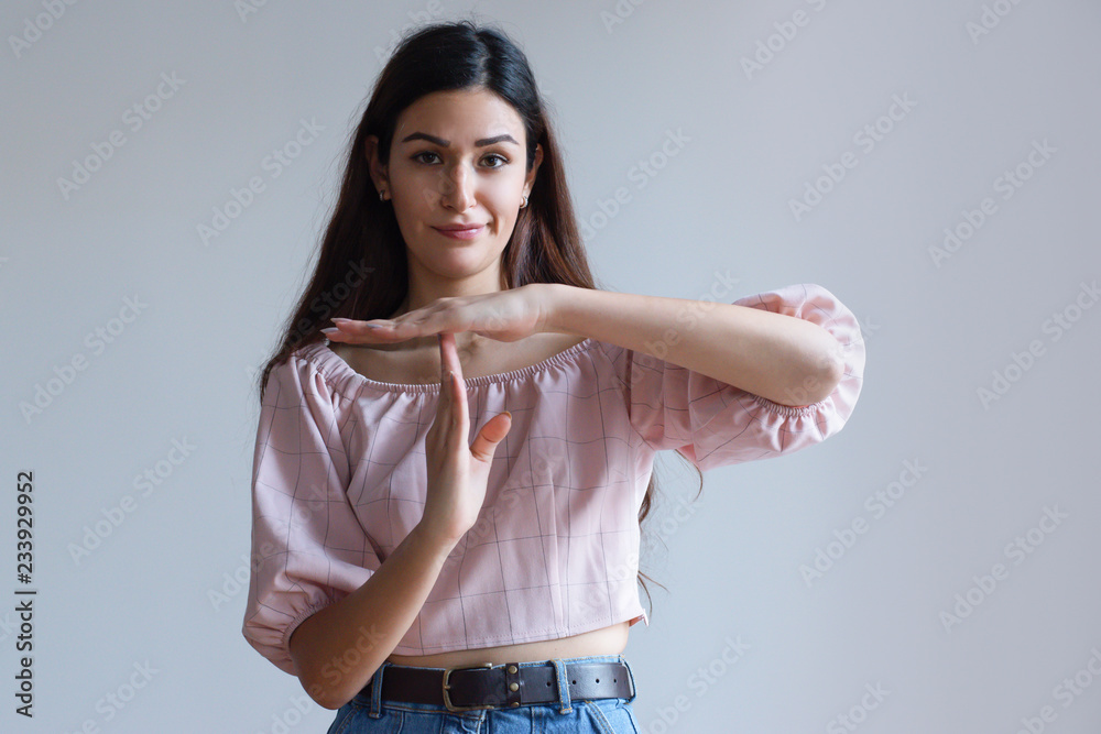 Positive pretty Caucasian girl showing time out symbol. Young female ...