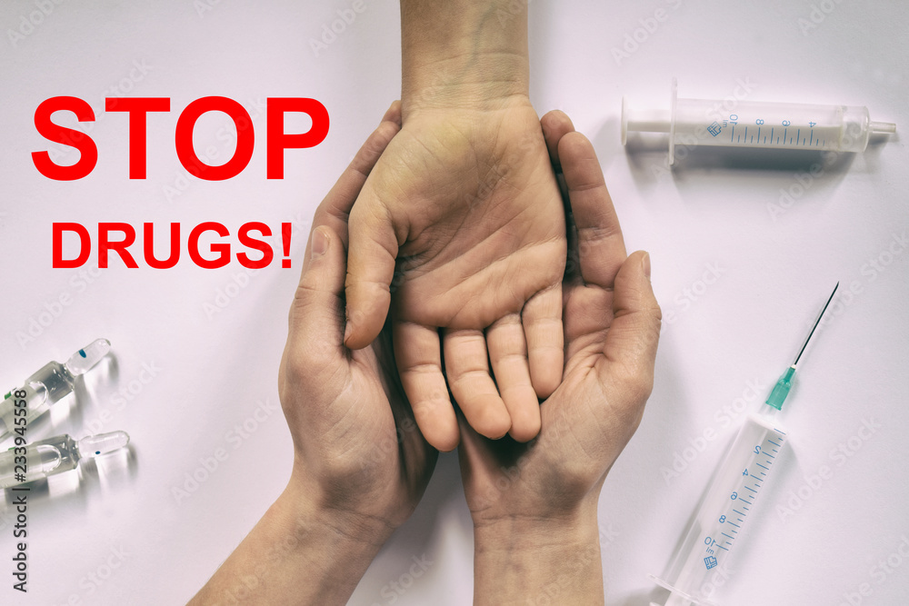 Hands helping drug addict teenage on white background with syringe and ...