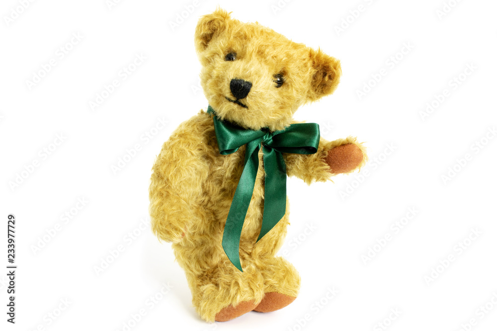 Cute teddy bear is standing with raised paw, toy is made from golden ...