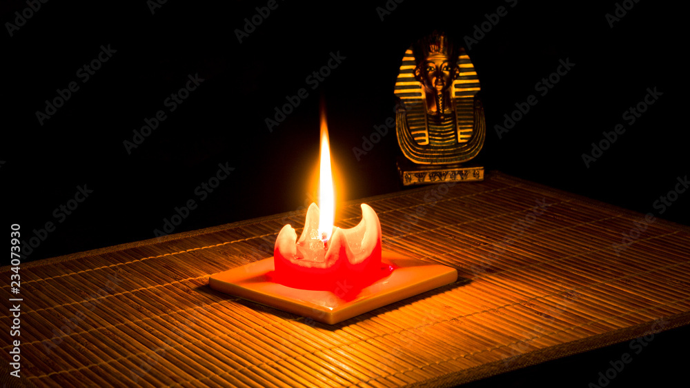 Statue of Tutankhamun lit by a candle Stock Photo | Adobe Stock